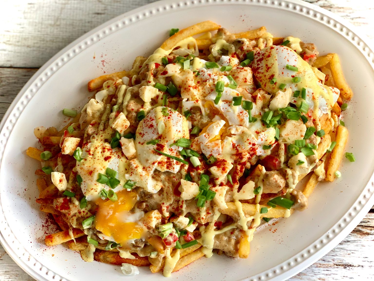 SUNDAY MORNING POUTINE WITH POACHED EGGS, SAUSAGE GRAVY, AND ...